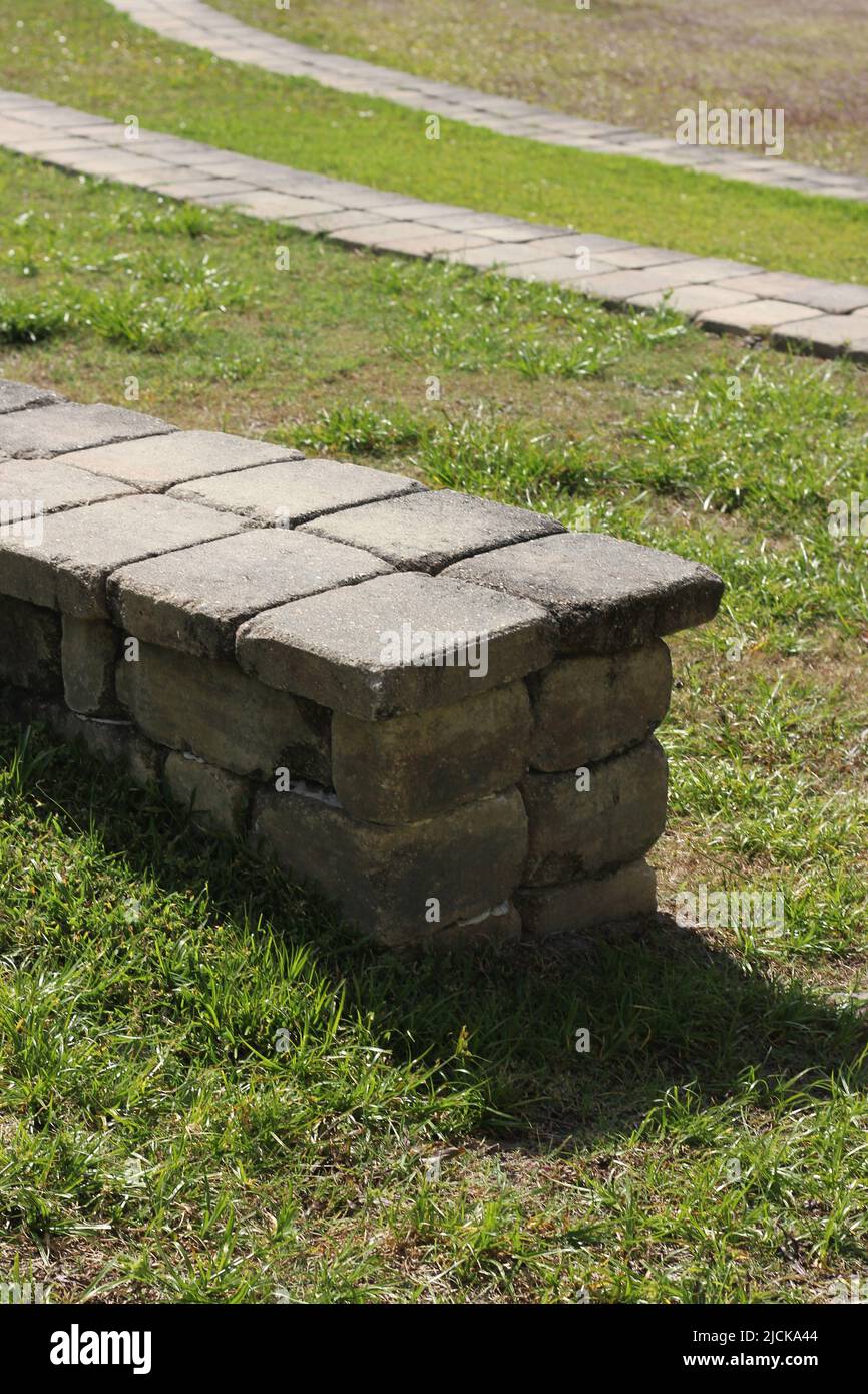 A natural stone bench as a simple seat and rest area at the park Stock ...