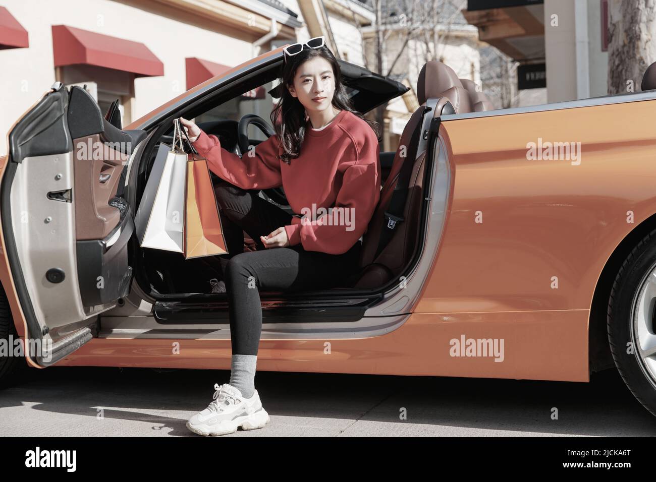 The fashionable young woman driving luxury shopping Stock Photo - Alamy