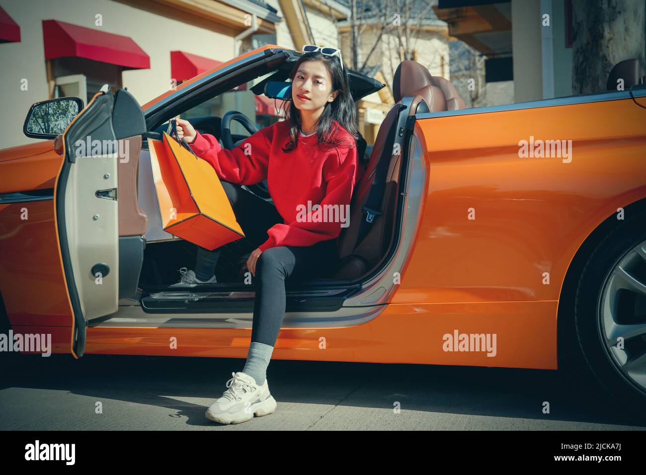 The fashionable young woman driving luxury shopping Stock Photo - Alamy