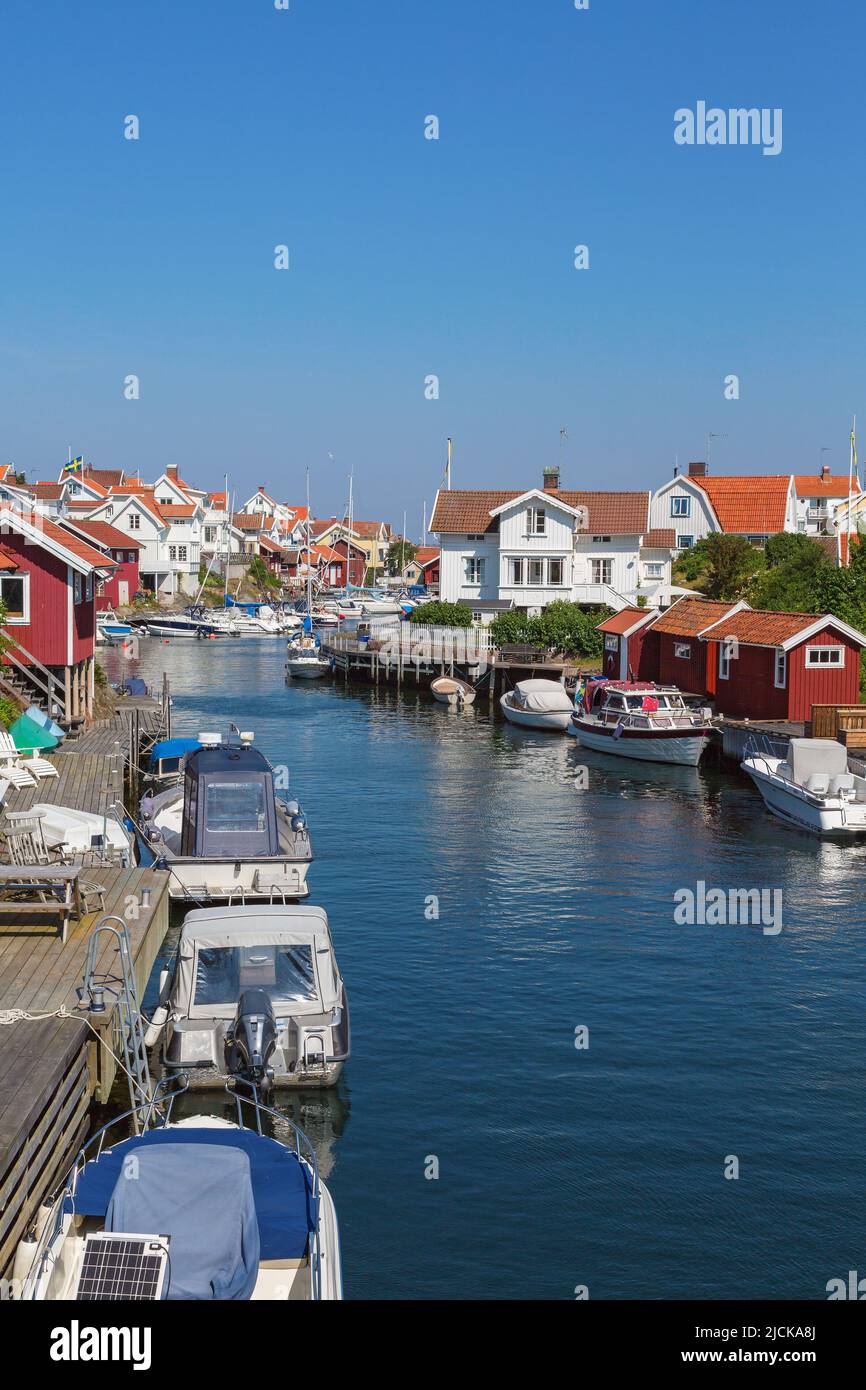 Channel for boats through a fishing village in sweden Stock Photo - Alamy
