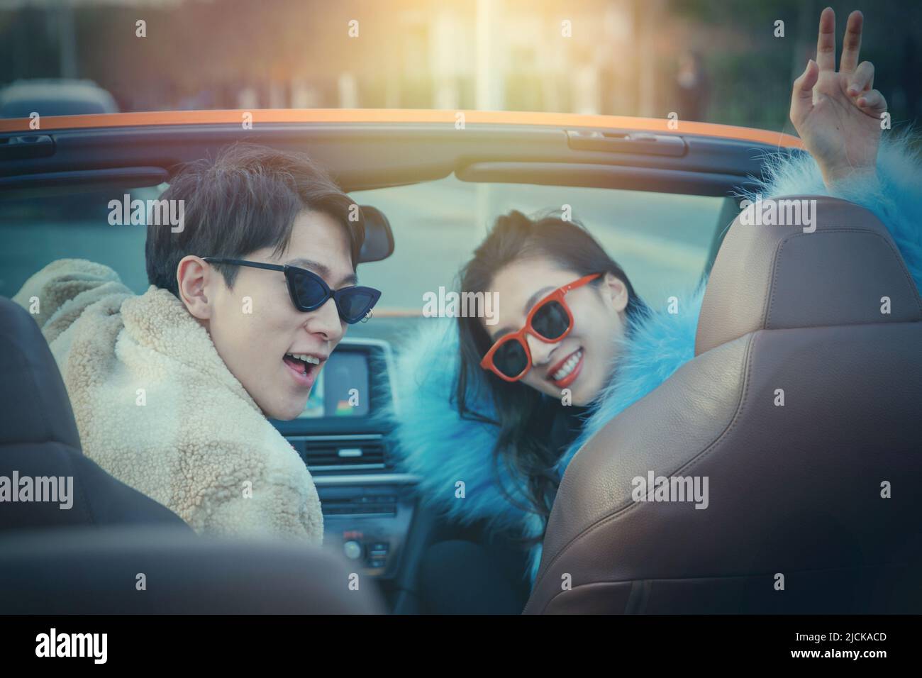 Fashionable young couples driving car for a ride Stock Photo - Alamy