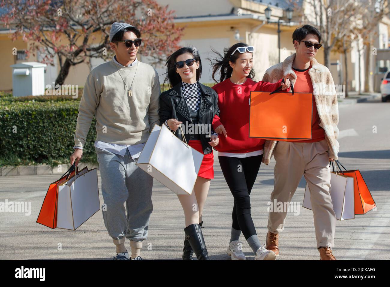 Happy fashionable young people go shopping Stock Photo - Alamy
