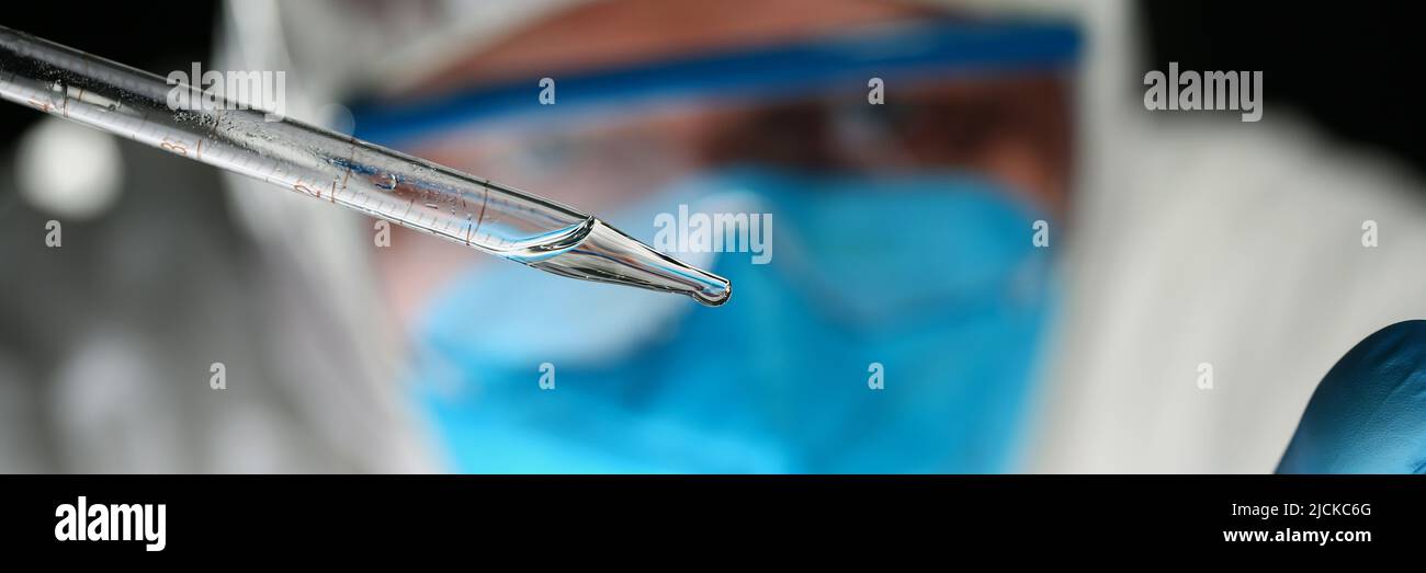 Science laboratory worker investigating chemical drug in glass ...