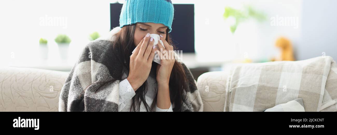 Sick woman having runny nose and use tissue covered with blanket Stock ...