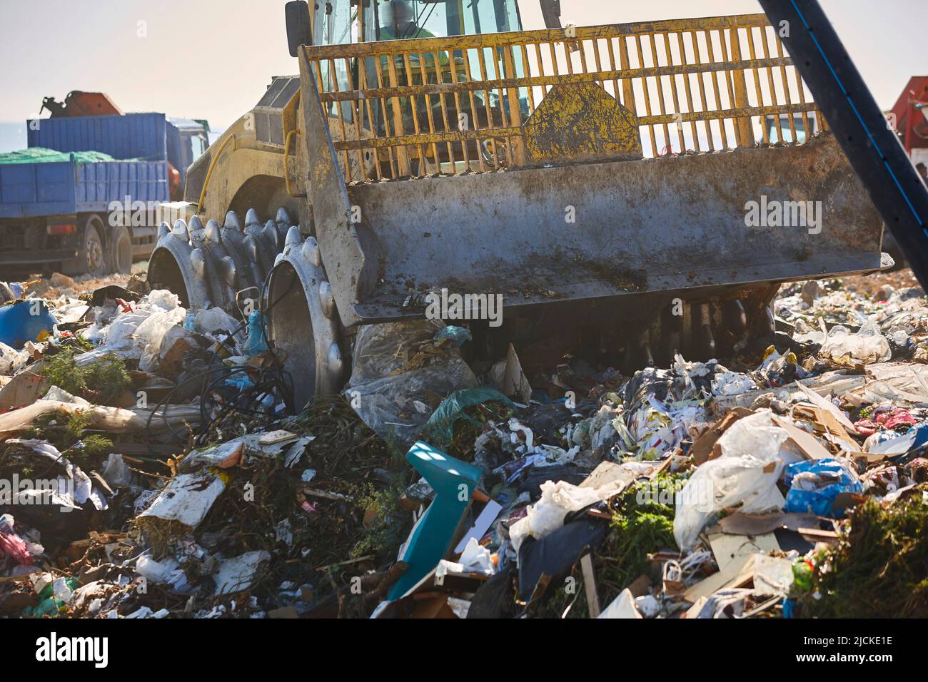 Heavy machinery shredding garbage in an open air landfill. Waste Stock ...