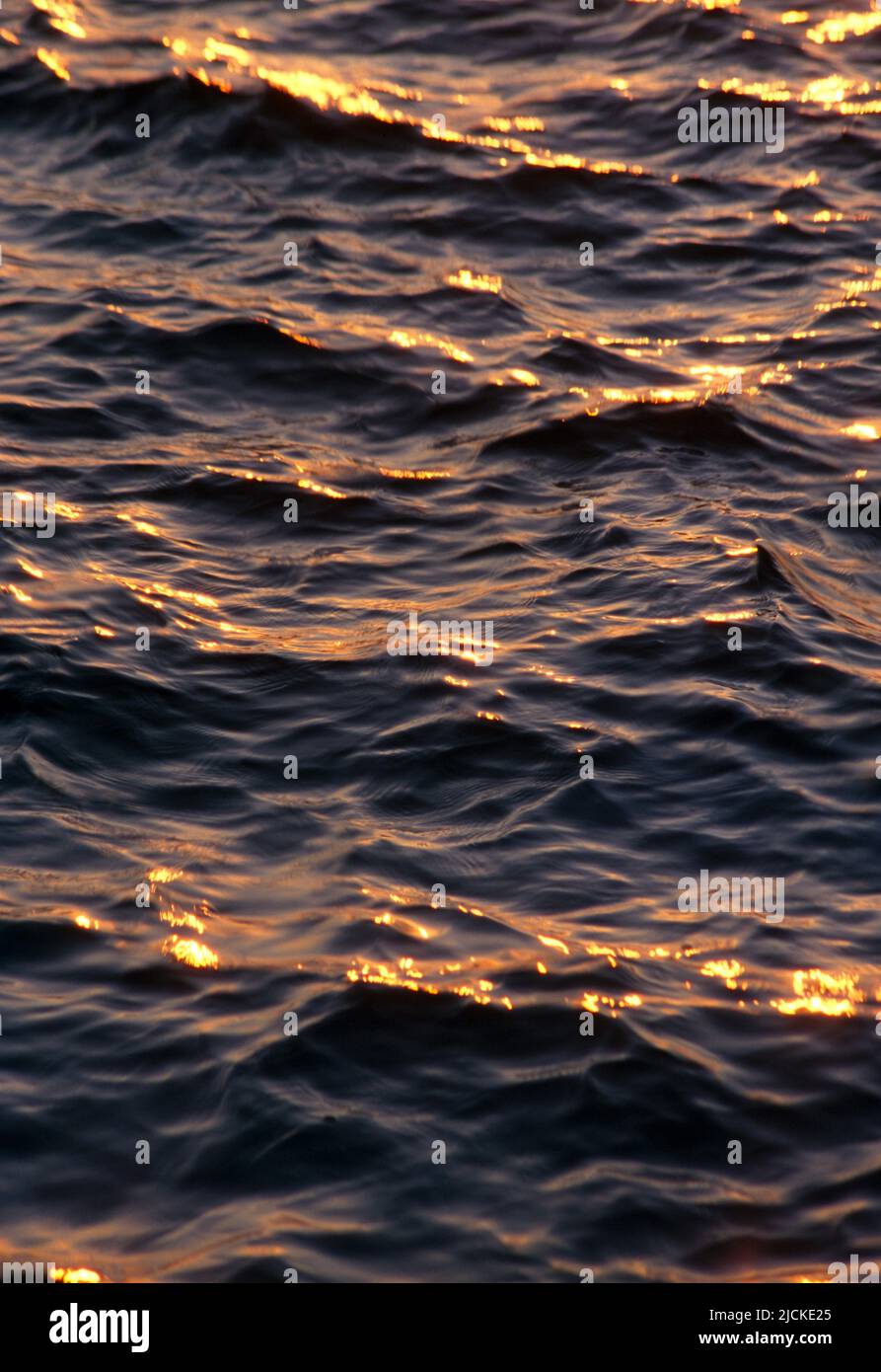 Abu Dhabi UAE Sunlight from Sunset reflecting on Small Waves in Sea ...