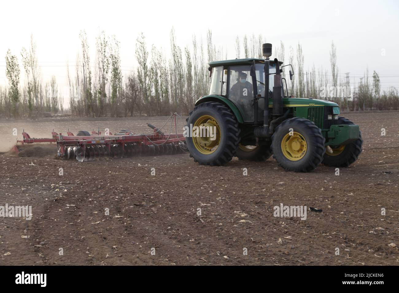 Xinjiang hami busy spring ploughing Stock Photo - Alamy