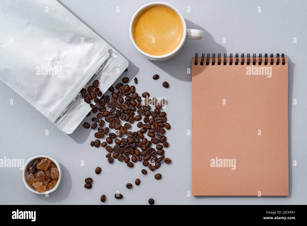 Cup of coffee with notebook on gray background top view Stock Photo - Alamy