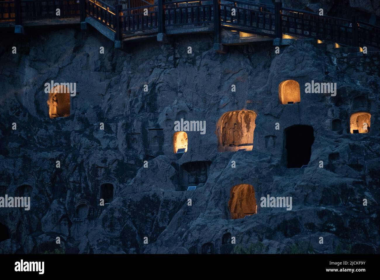Luoyang longmen grottoes with light at night Stock Photo - Alamy