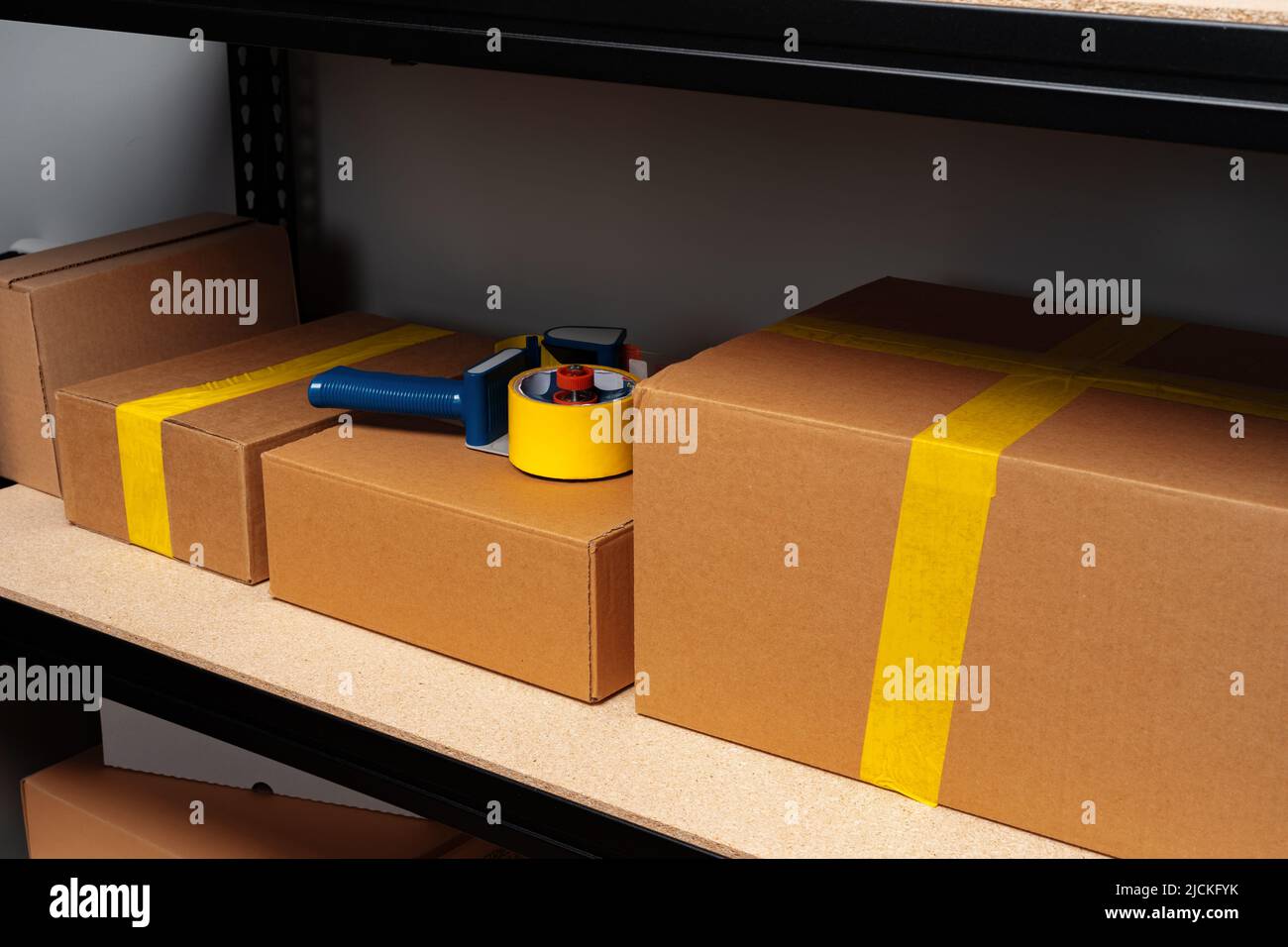 Warehouse shelves with small paper boxes, close up Stock Photo - Alamy