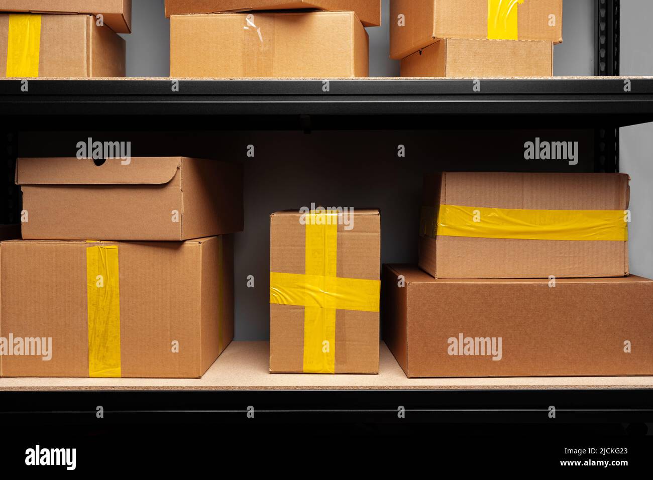 Rows of shelves with cardboard boxes in modern warehouse Stock Photo ...