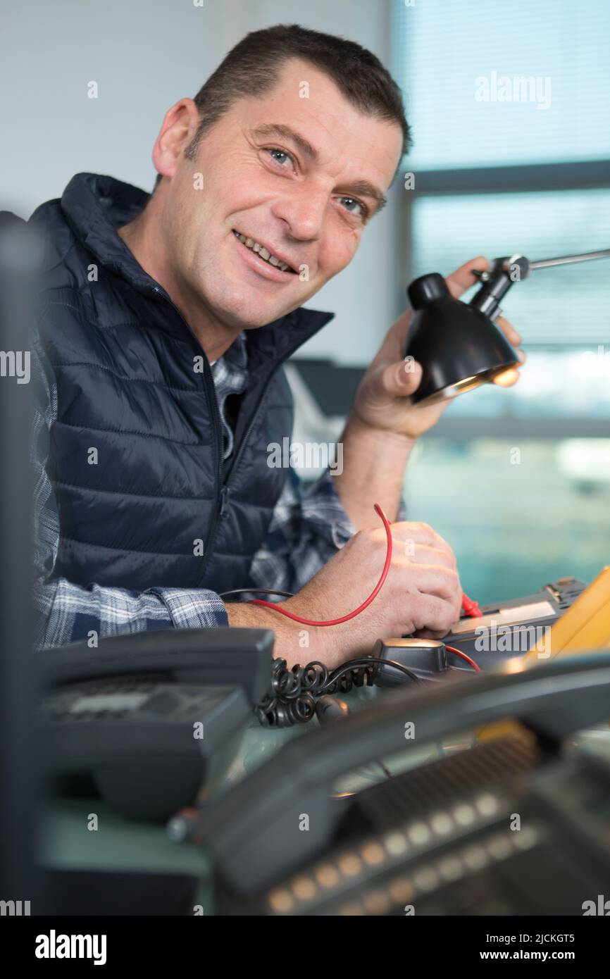 happy computer engineer working on broken console Stock Photo - Alamy