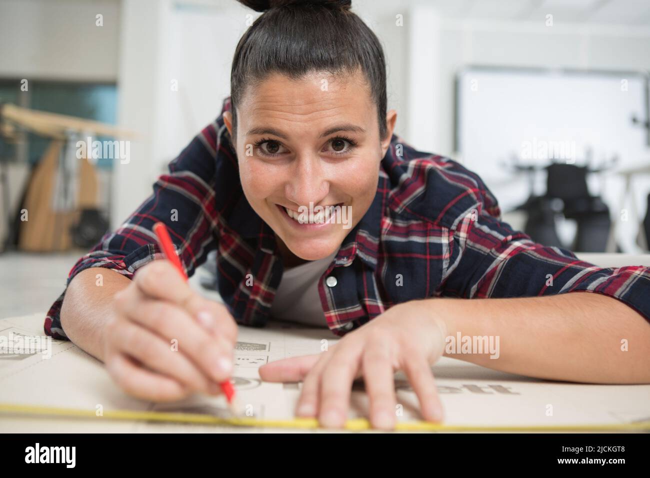 woman drawing something on blueprint Stock Photo - Alamy