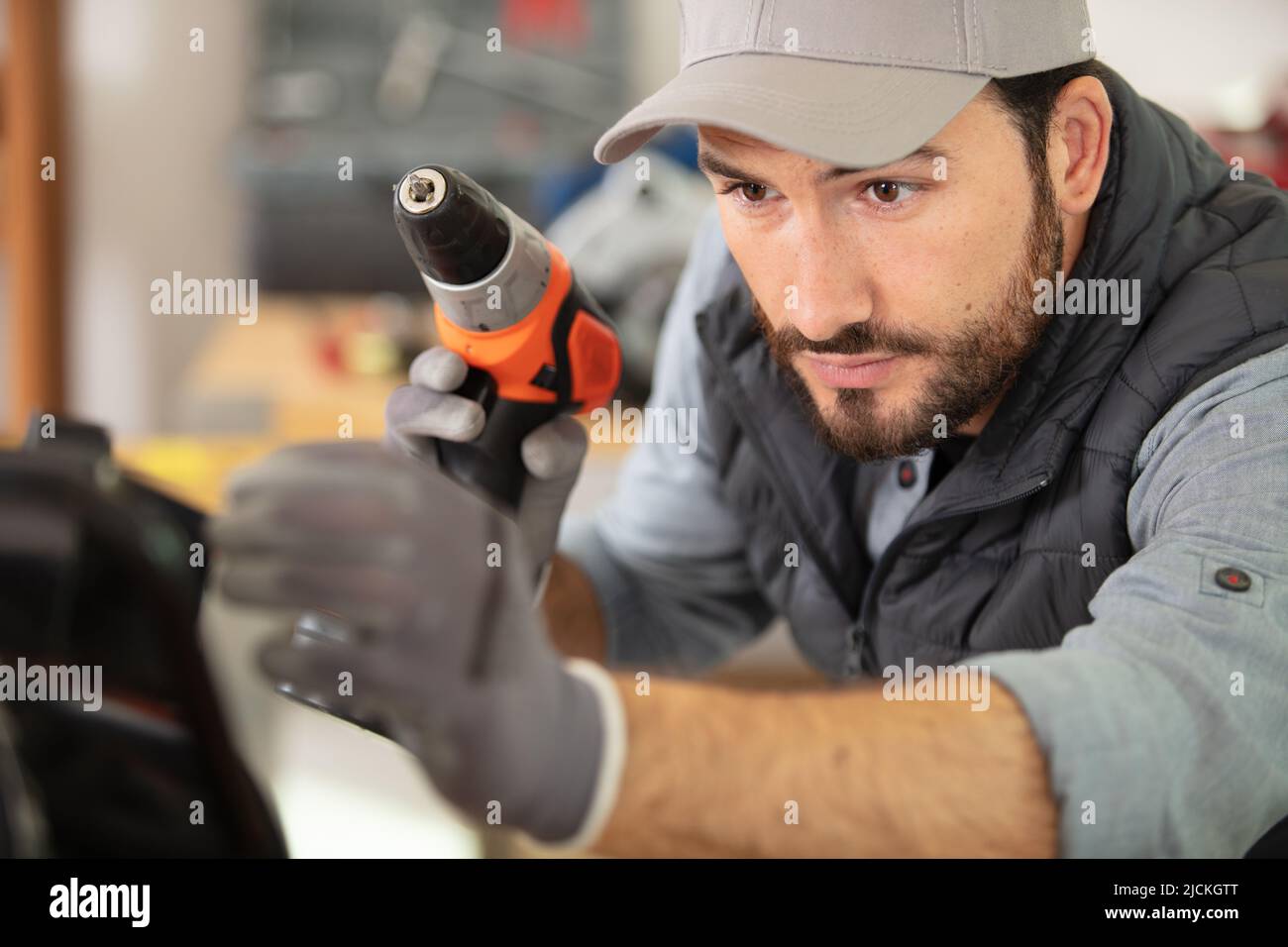close view of workman using cordless screwdriver Stock Photo - Alamy