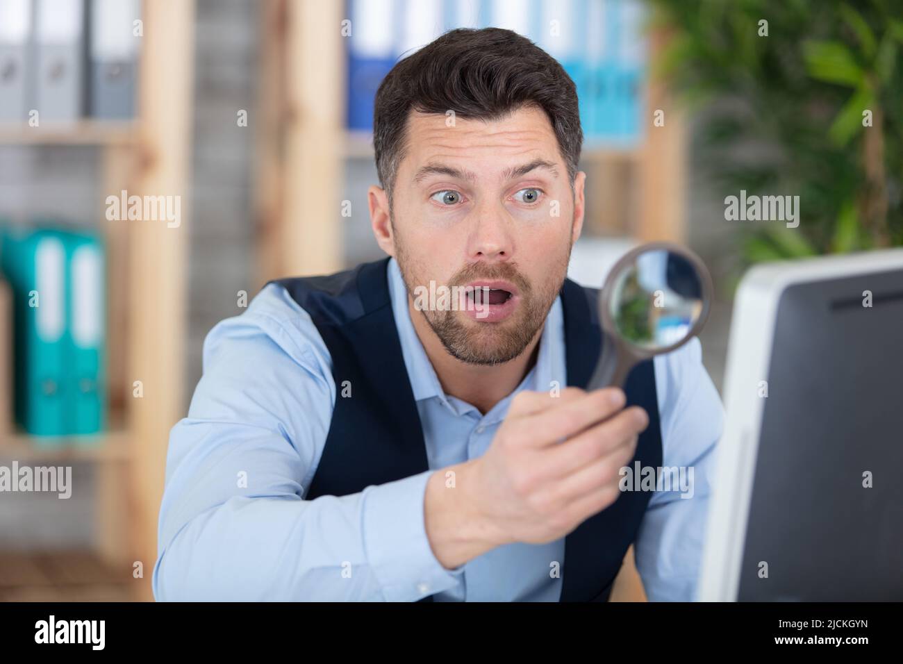 a man holding magnifying glass Stock Photo - Alamy