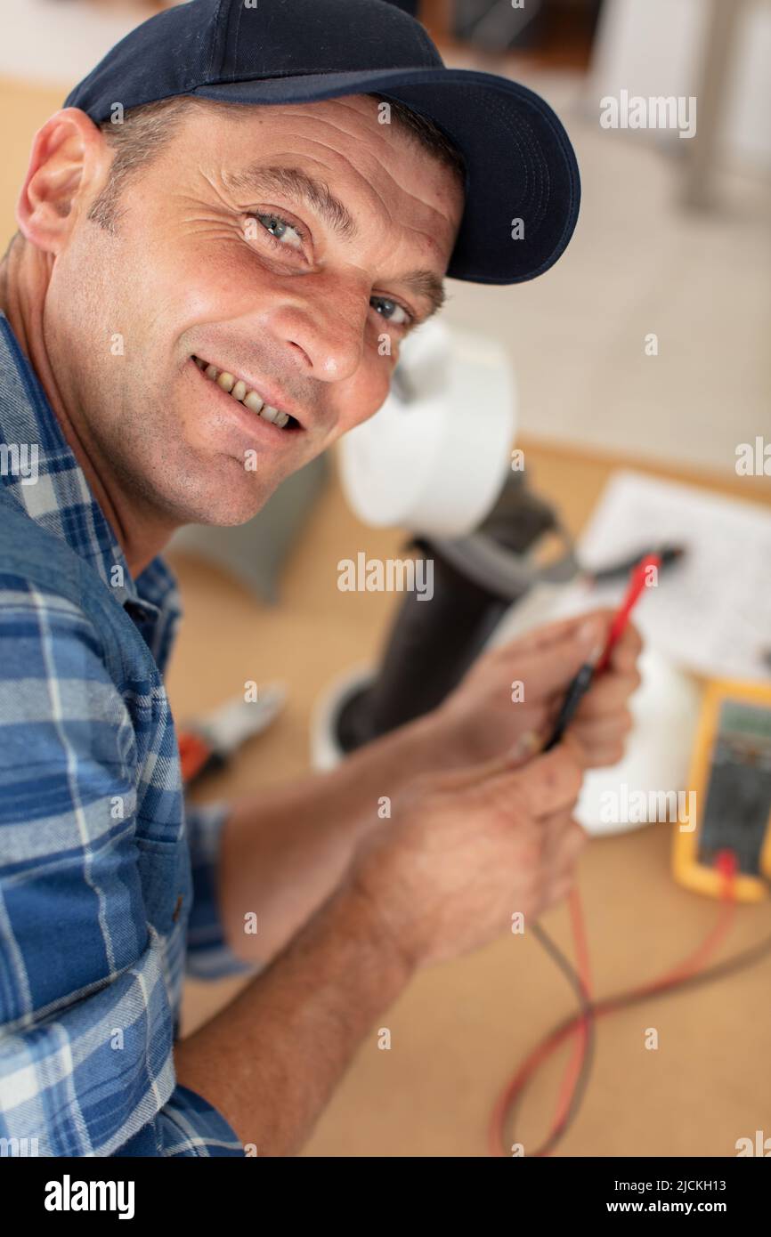 happy man fixing electronic appliance Stock Photo - Alamy