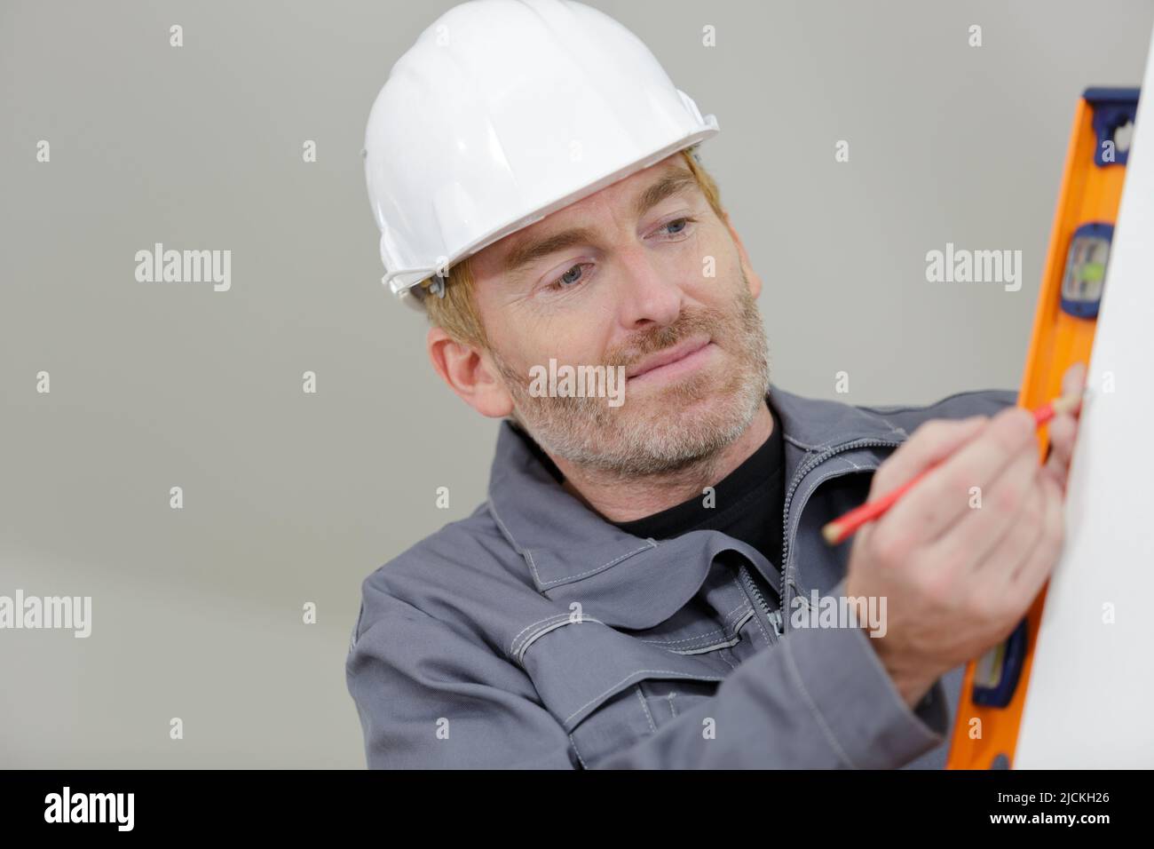 happy smiling constructor holding tool Stock Photo - Alamy