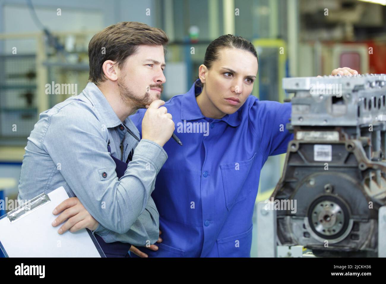 two engineers using cad programming software on factory machine Stock ...