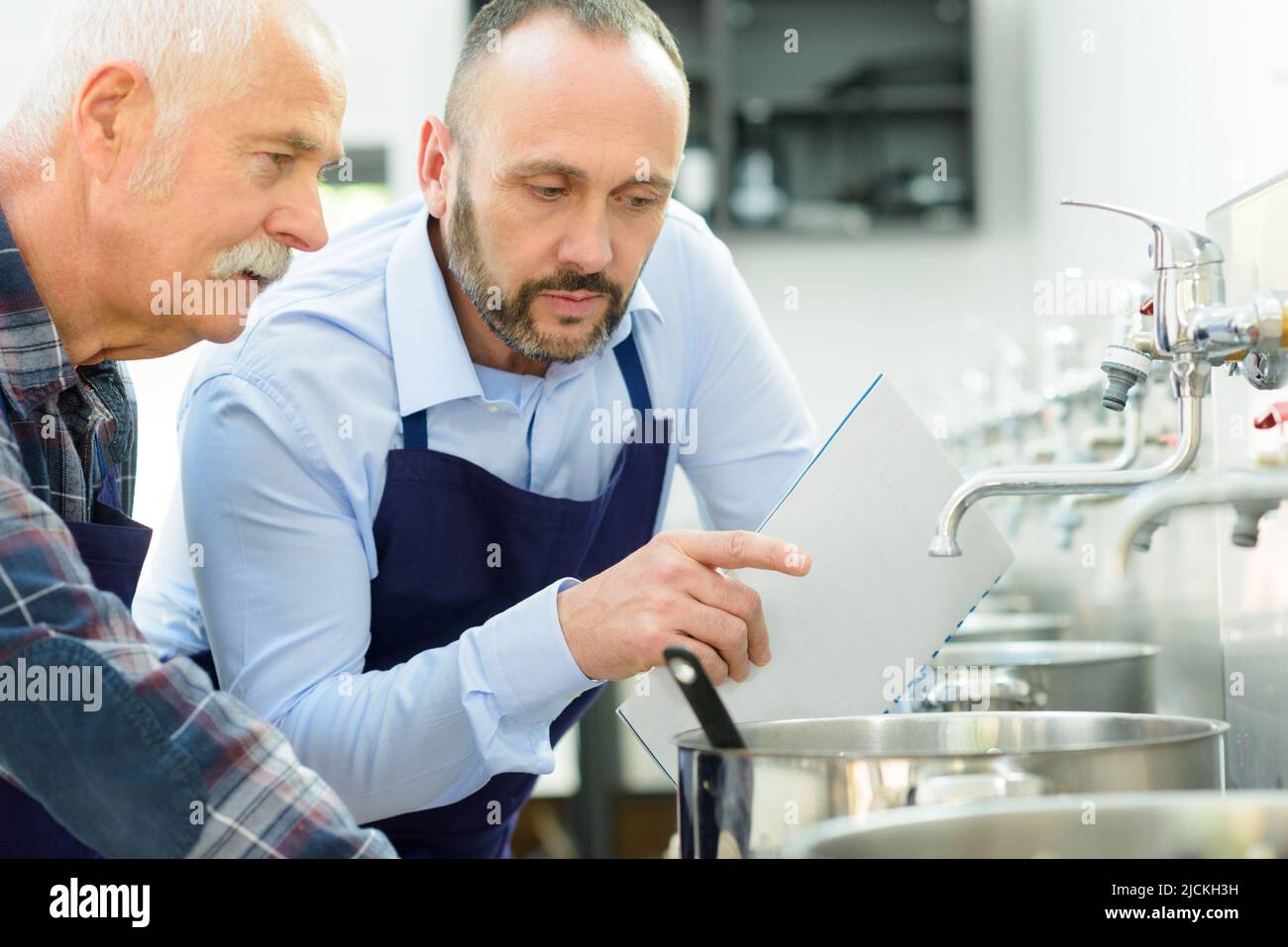concentrated man making notes in brewery Stock Photo - Alamy
