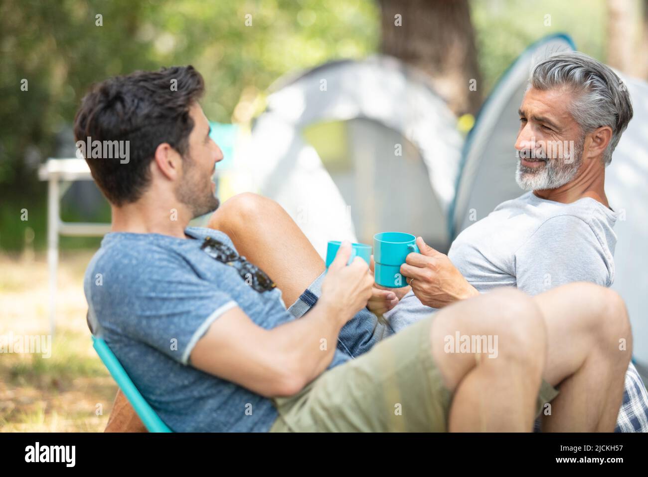two men enjoying in the camping Stock Photo - Alamy