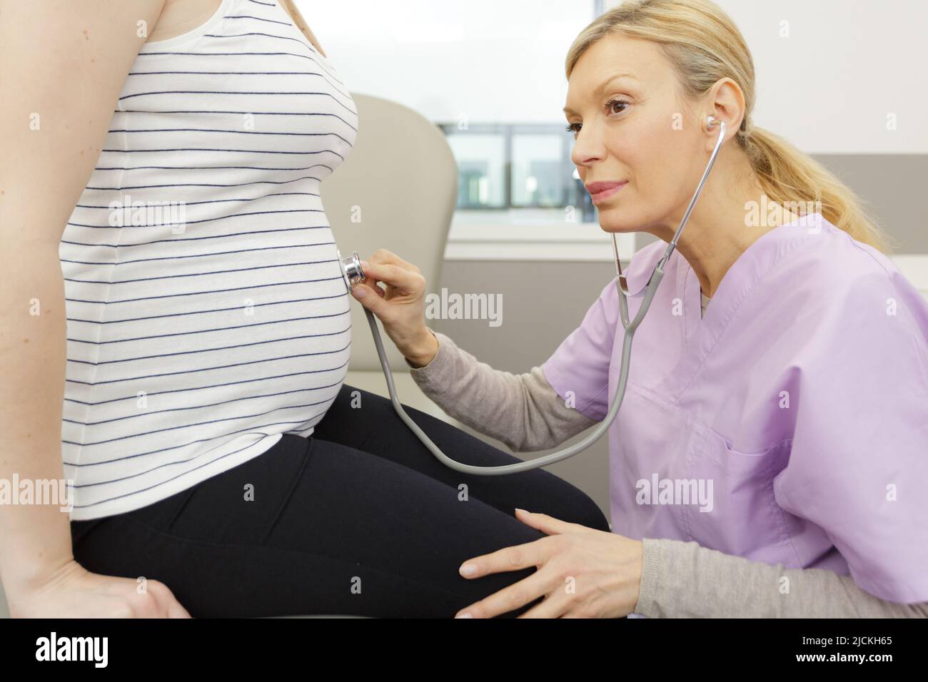 doctor using stethoscope on pregnant woman belly Stock Photo - Alamy
