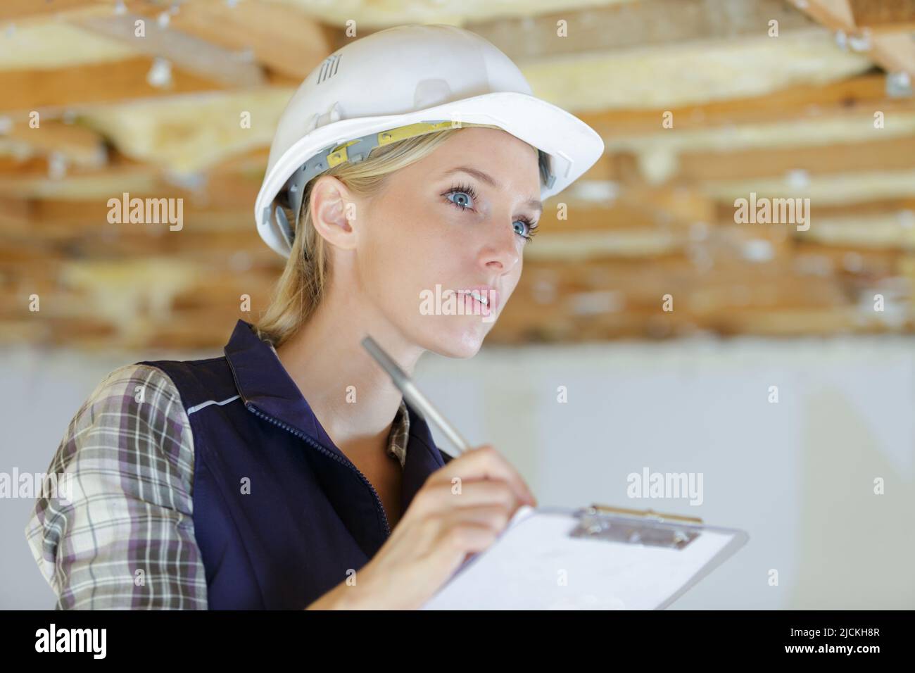 woman builder writing on clipboard Stock Photo - Alamy