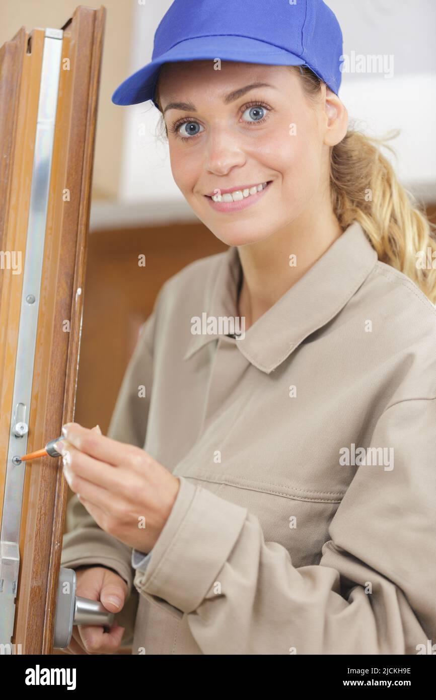 Woman locksmith fixing lock hi-res stock photography and images - Alamy