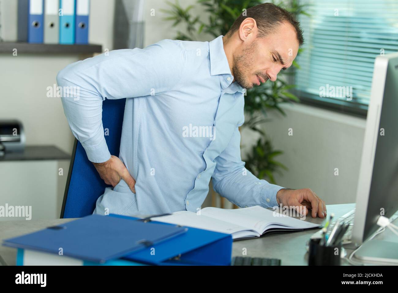 office worker having pain at lower back Stock Photo - Alamy