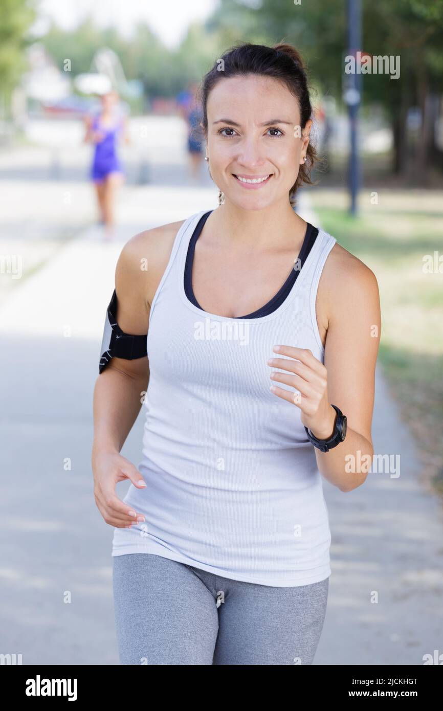 sporty female jogger running and training outside in nature Stock Photo ...
