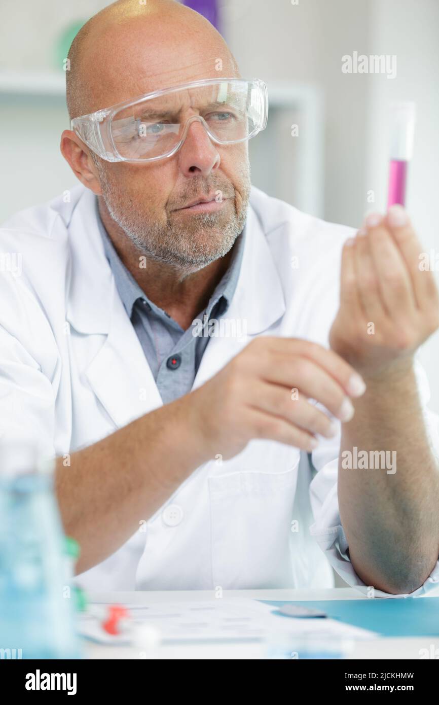 senior scientist holding test tube Stock Photo - Alamy