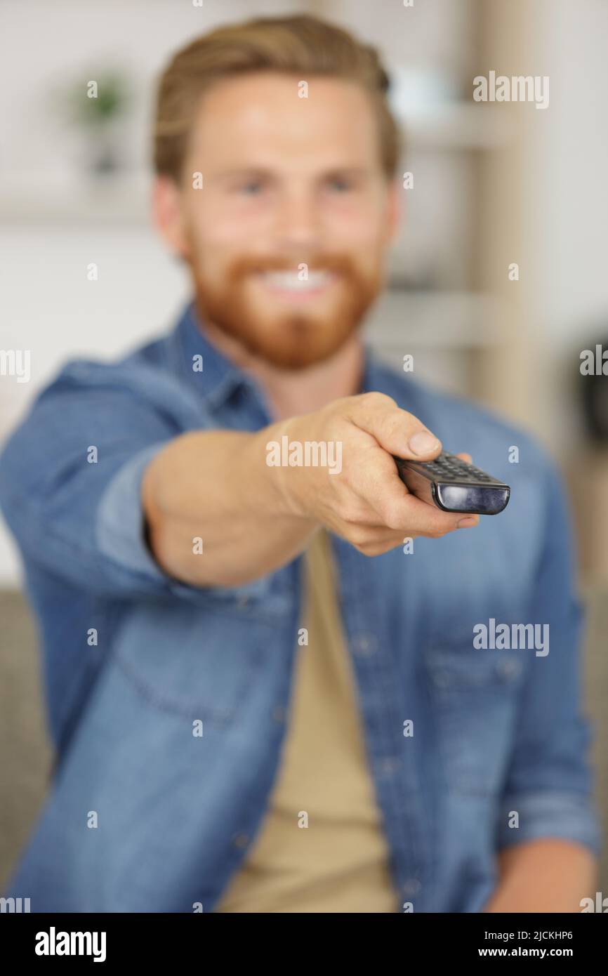handsome man changing tv channels with remote control at home Stock ...