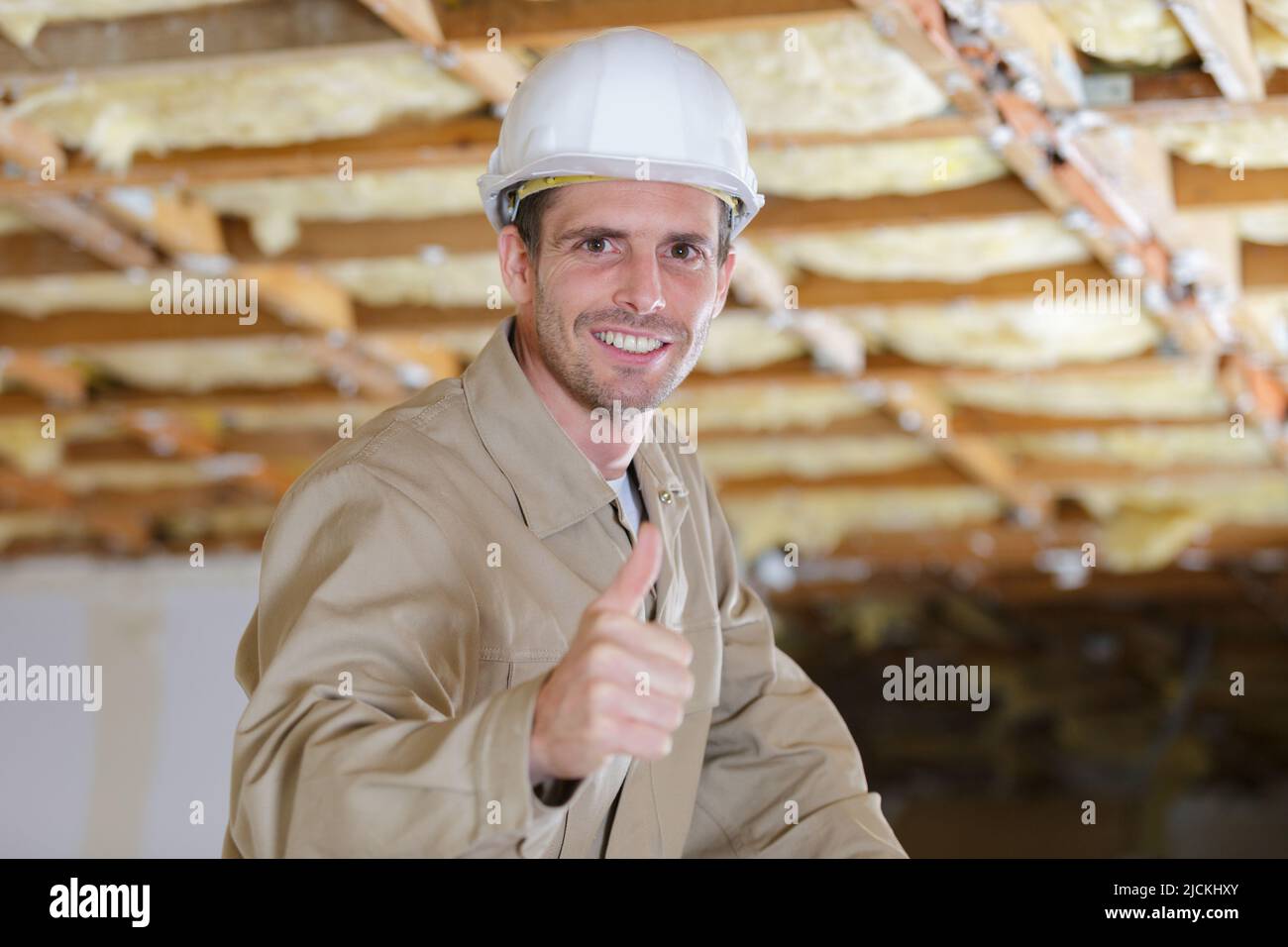 smiling construction inspectorbuilder standing on ladder with his thumb ...