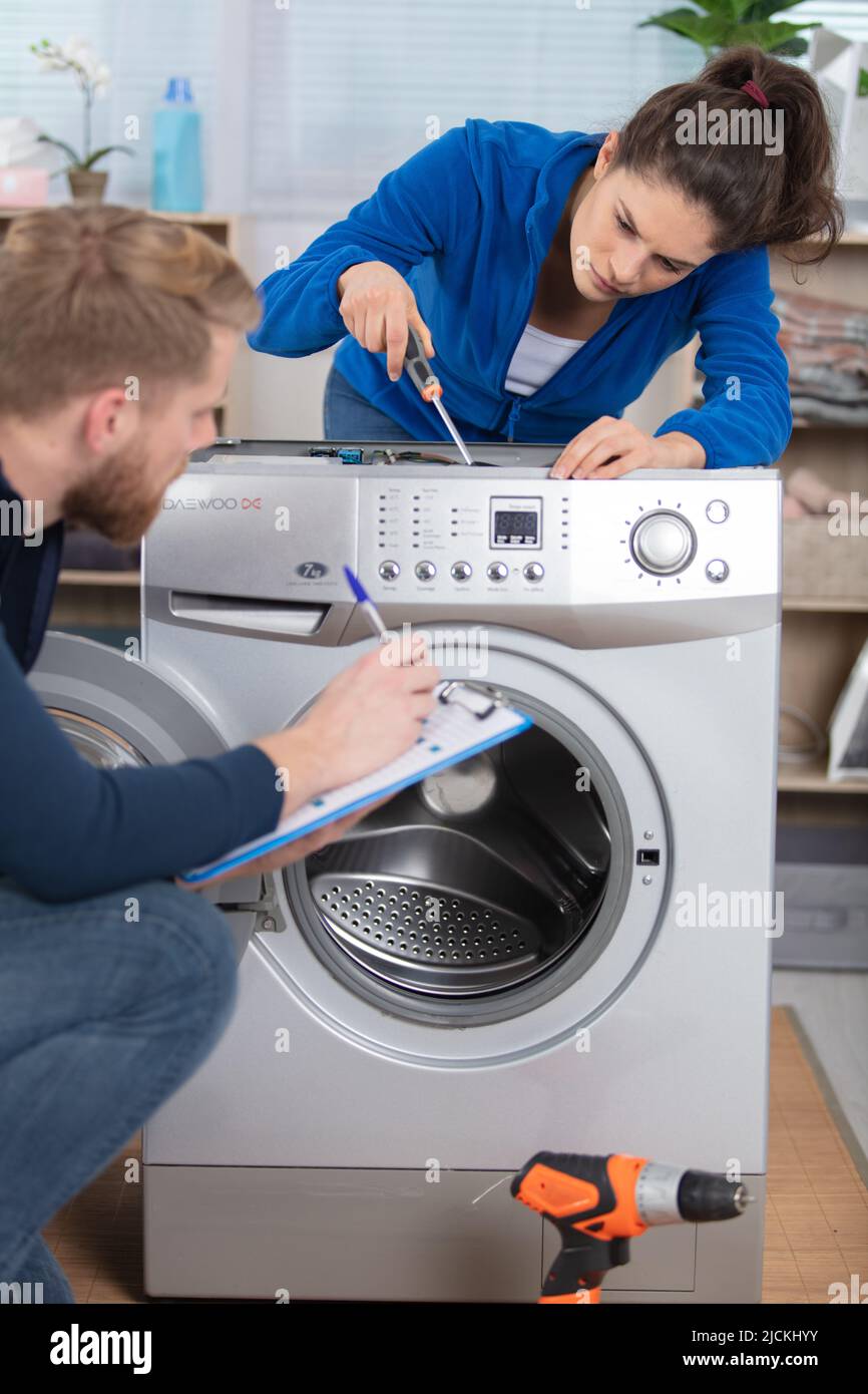 Woman trying repair washing machine hi-res stock photography and images ...