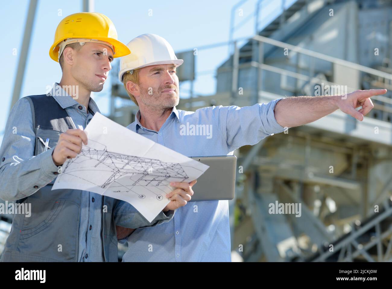 architect pointing up while guiding Stock Photo - Alamy