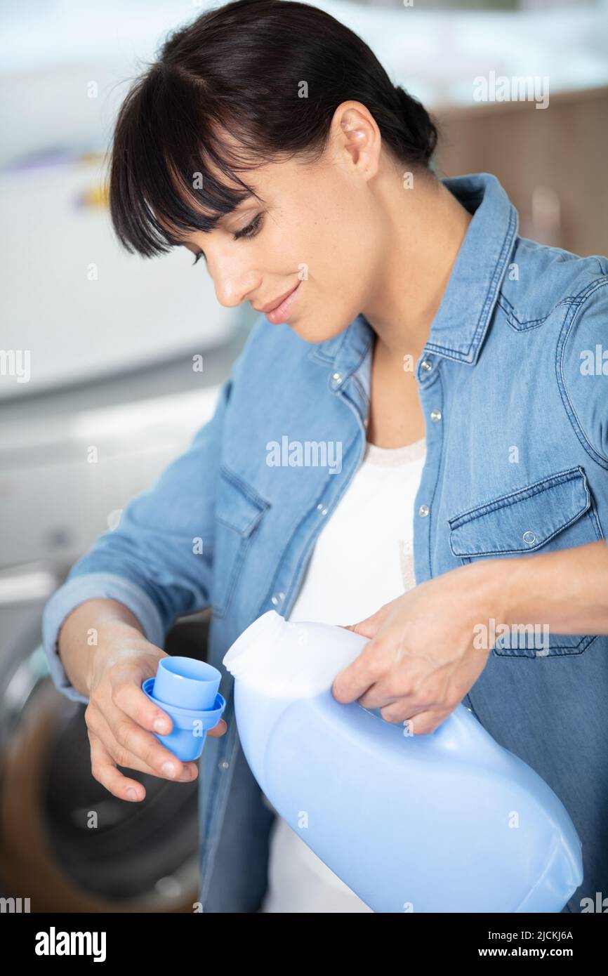 Woman pouring liquid detergent in hi-res stock photography and images ...