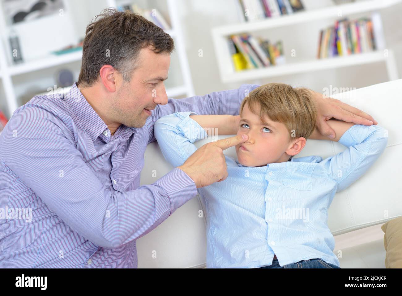 Man pressing nose of young child Stock Photo - Alamy
