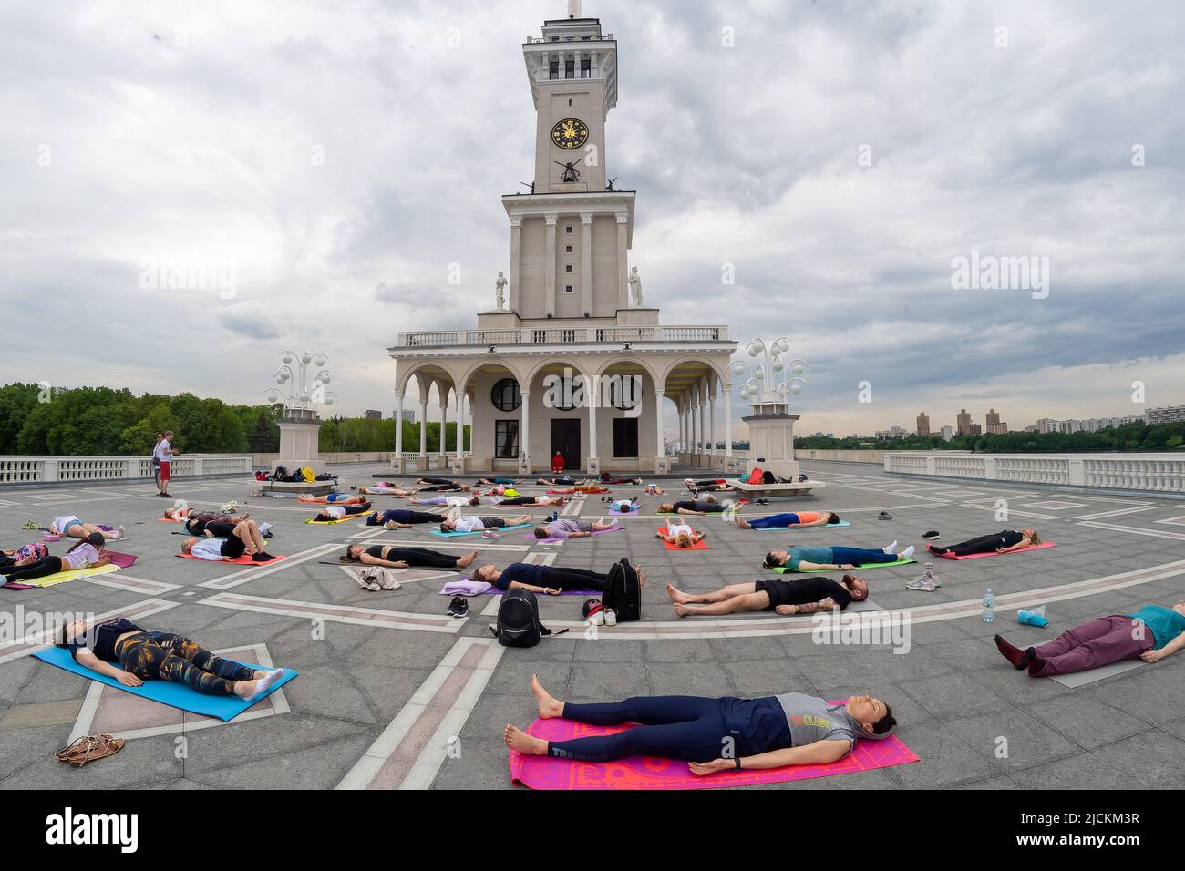 Moscow. Girls practice yoga on a roof of the Northern river station ...