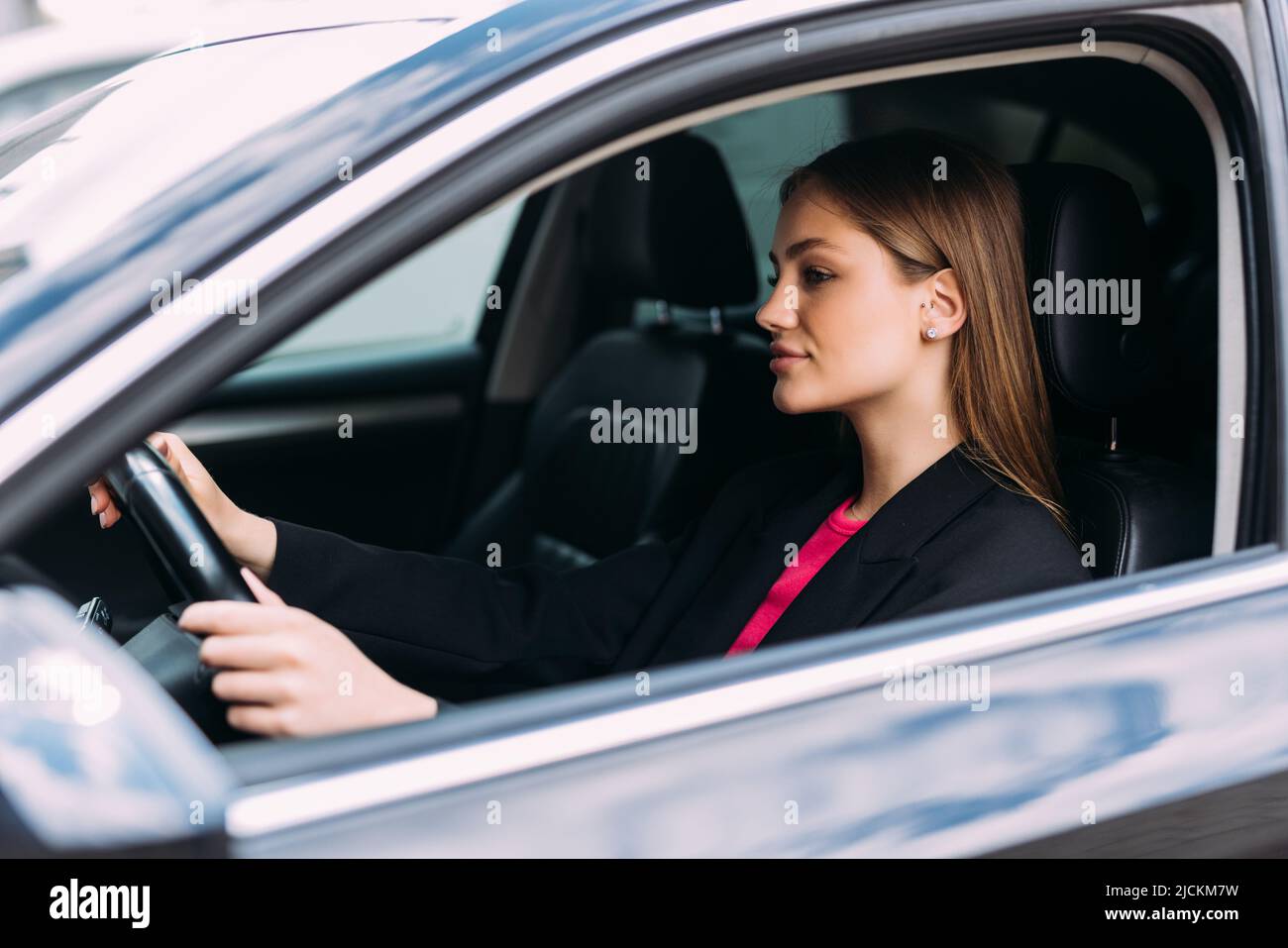 Happy woman driving a car and smiling. Cute young success happy ...