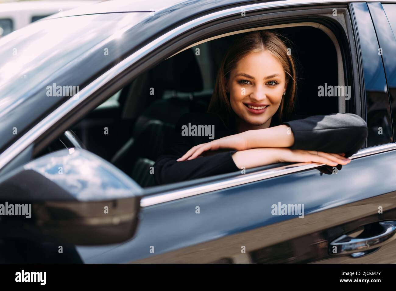 Beautiful young happy smiling woman driving her car Stock Photo - Alamy