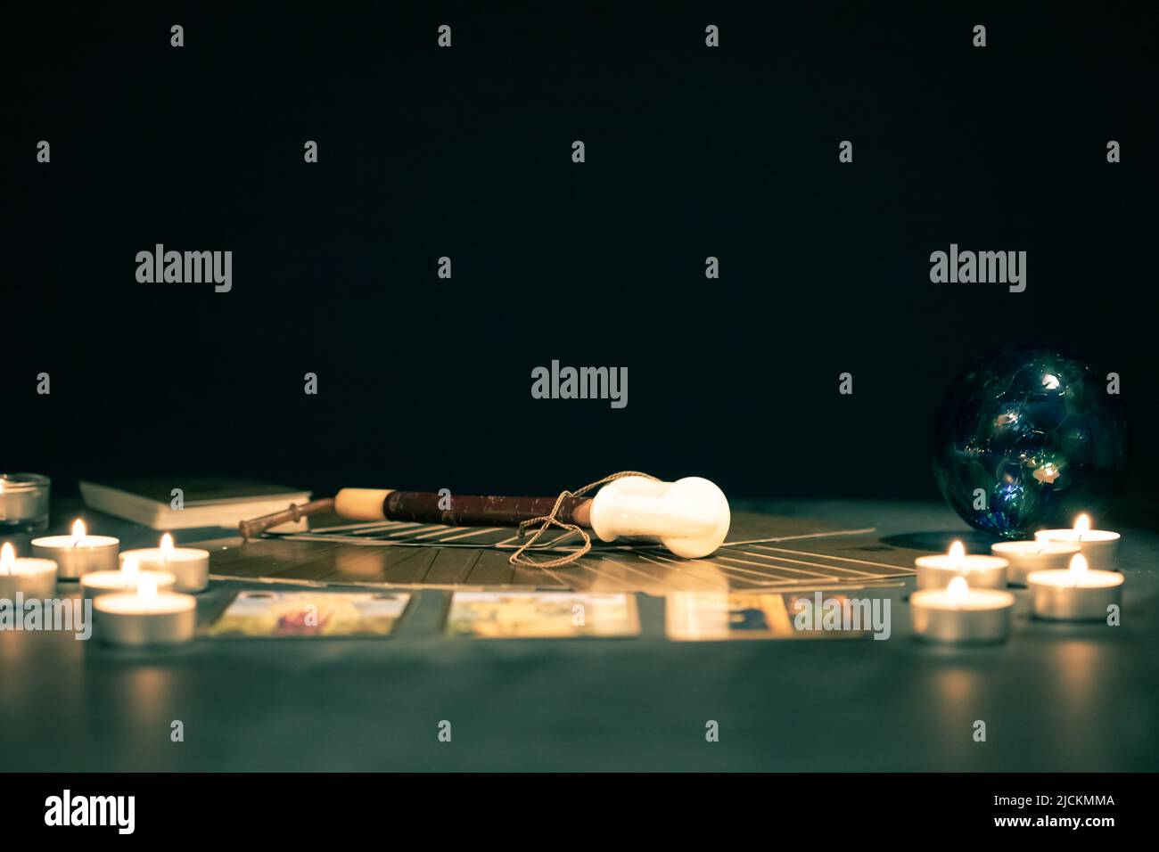 Tarot cards on table near burning candles.Tarot cards spread on table ...