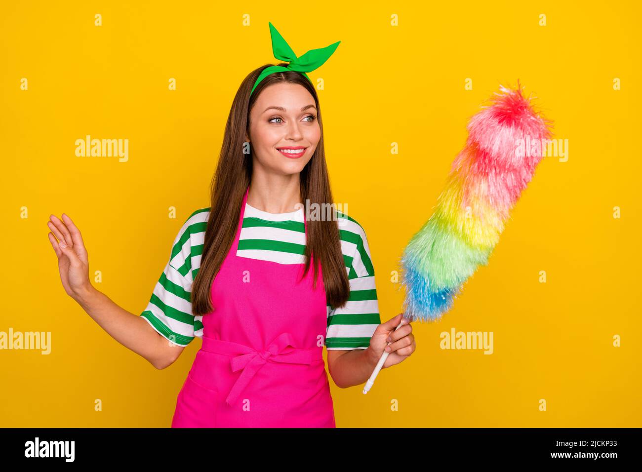 Photo of pretty cheerful person hold duster look empty space toothy ...