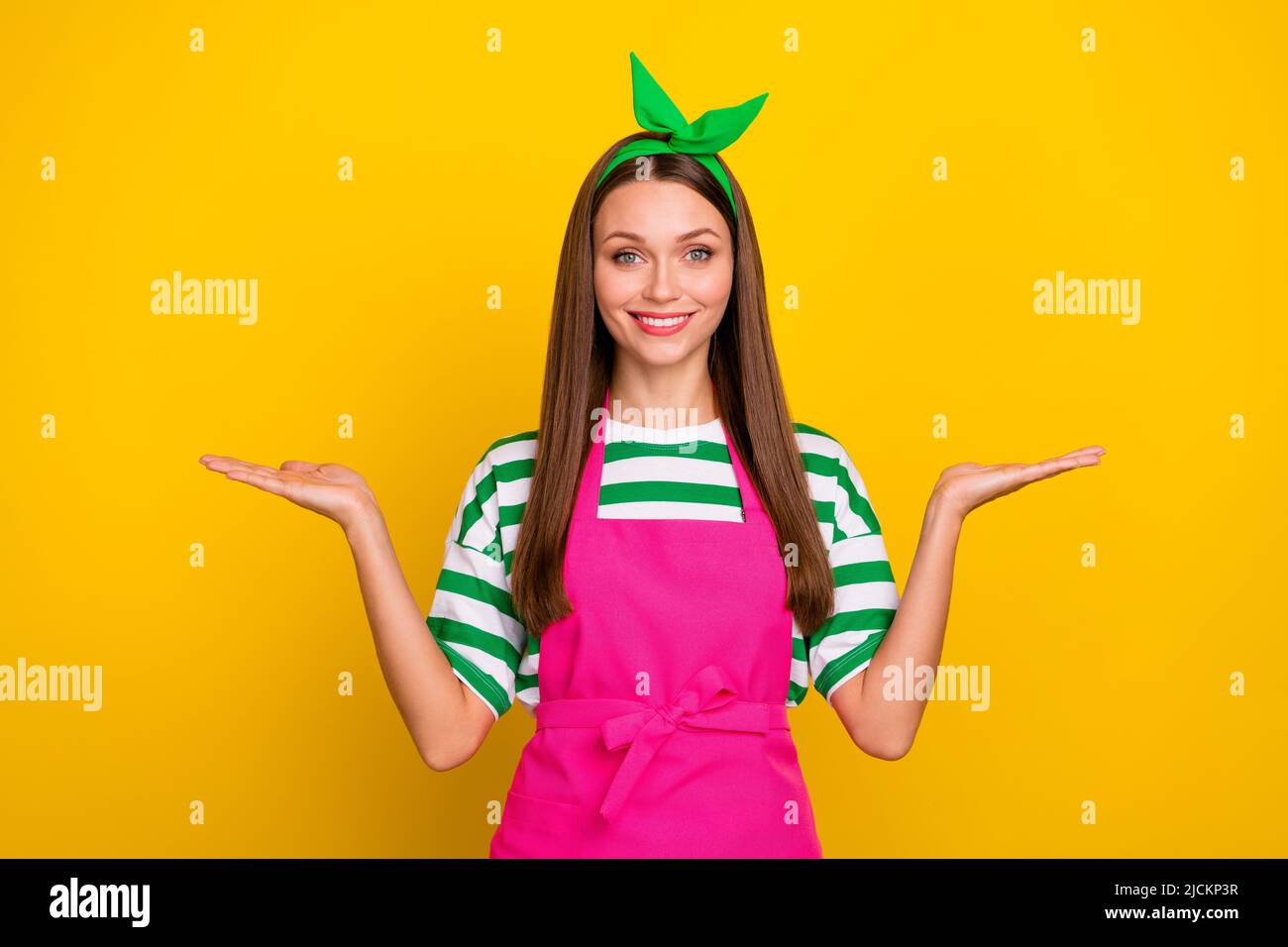 Photo of cheerful attractive girl arms palms demonstrate empty space vs ...