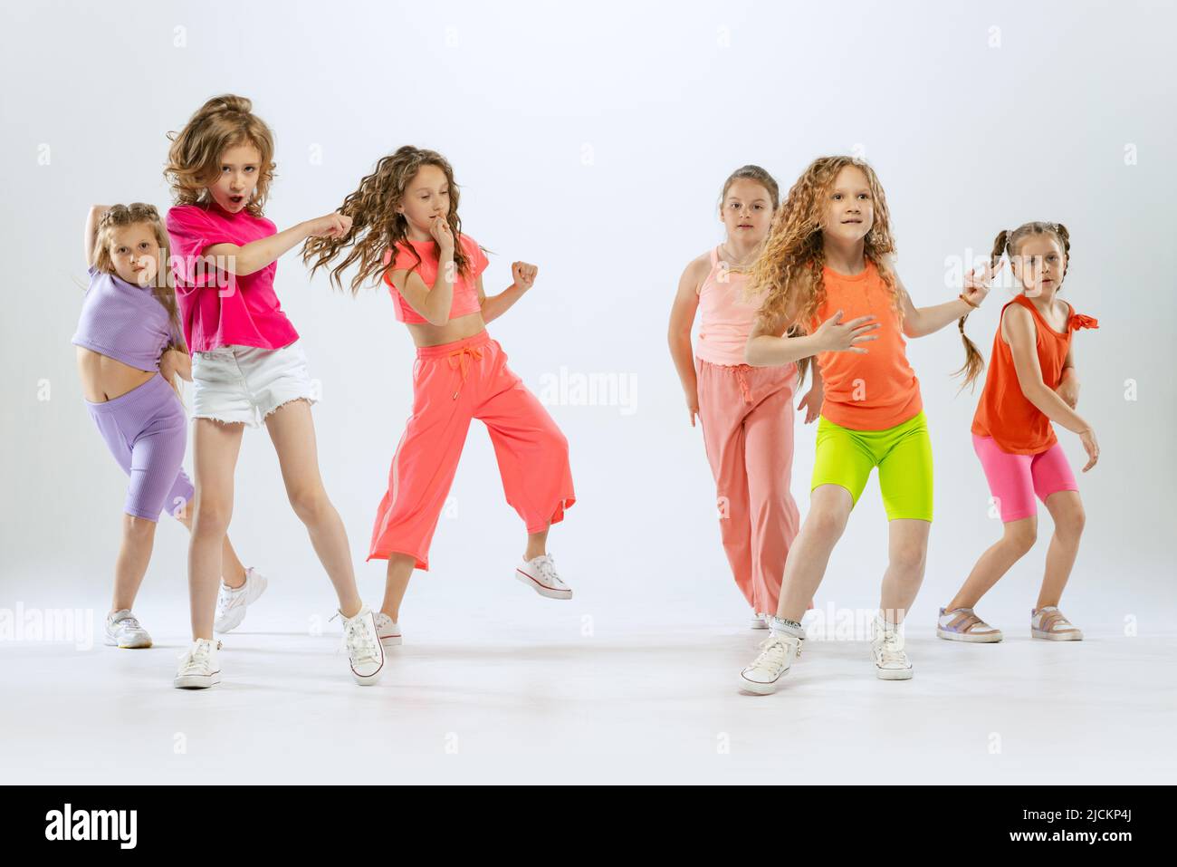 Happy, sportive little girls, kids in bright colorful clothes dancing ...