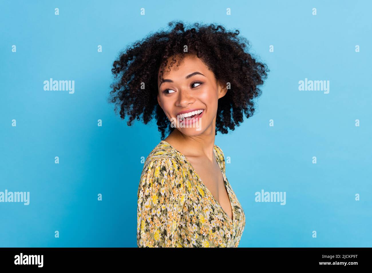 Photo of shiny charming lady dressed print outfit smiling looking back ...