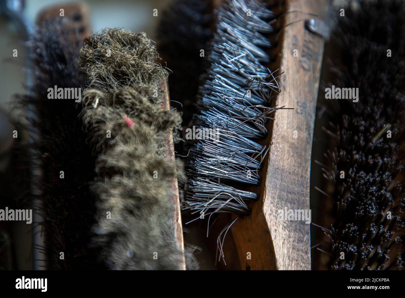 A jumble of wire brushes in a workshop Stock Photo - Alamy