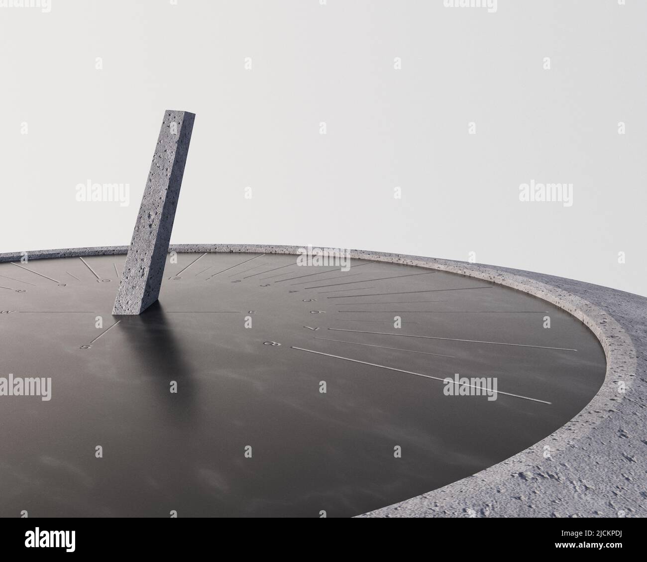 A modern round stone sundial with etched roman numerals standing an a ...