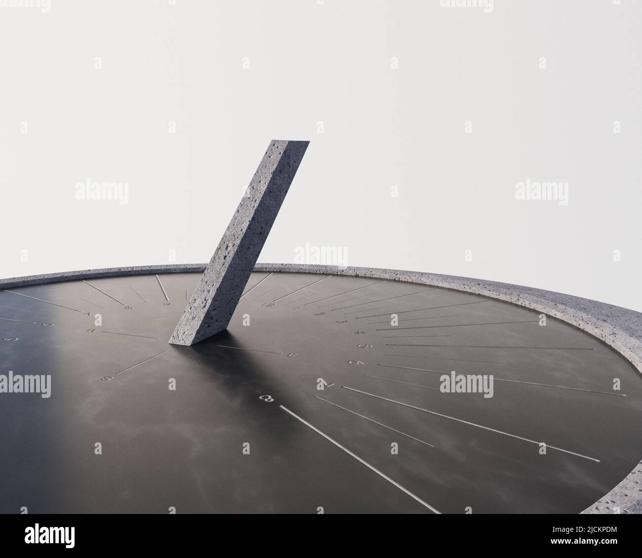 A modern round stone sundial with etched roman numerals standing an a ...