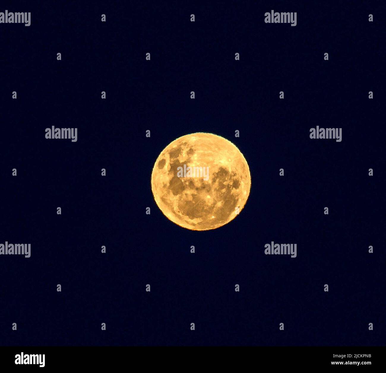 a close up shot of a Super moon rising over Mount Dobson on the shores ...