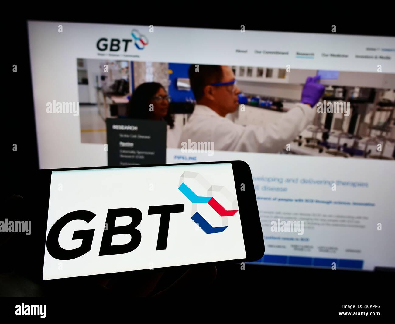 Person holding cellphone with logo of US company Global Blood ...