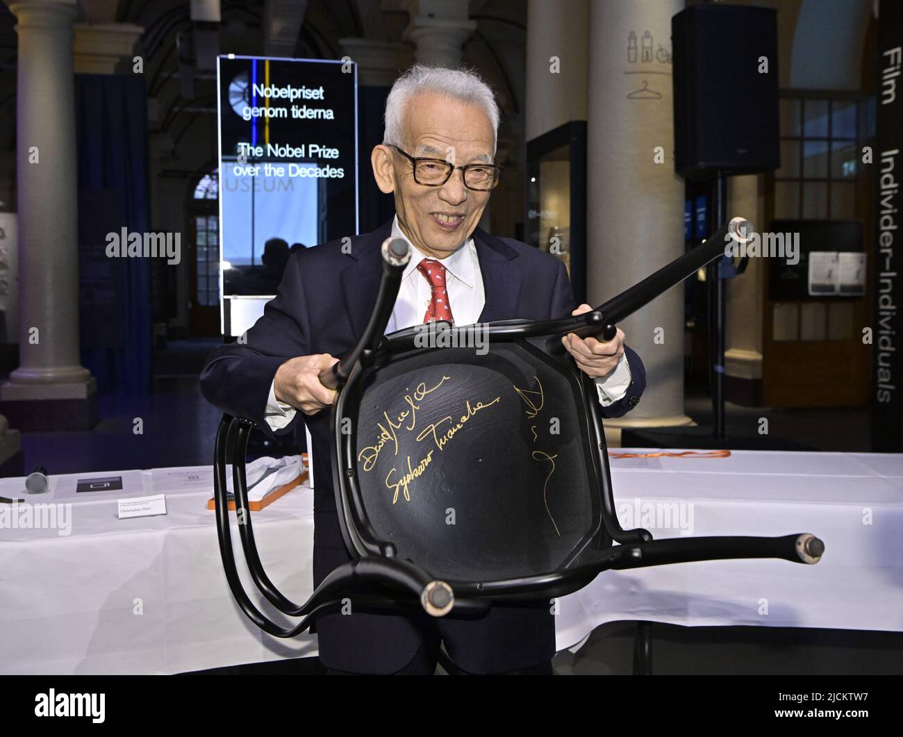 Syukuro Manabe (Physics 2021) signs a chair during a visit to the Nobel ...
